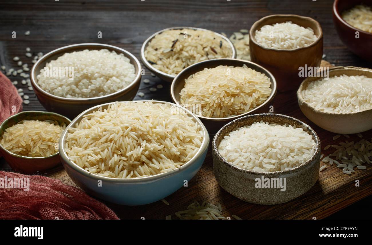 different types of rice on dark wooden table Stock Photo - Alamy