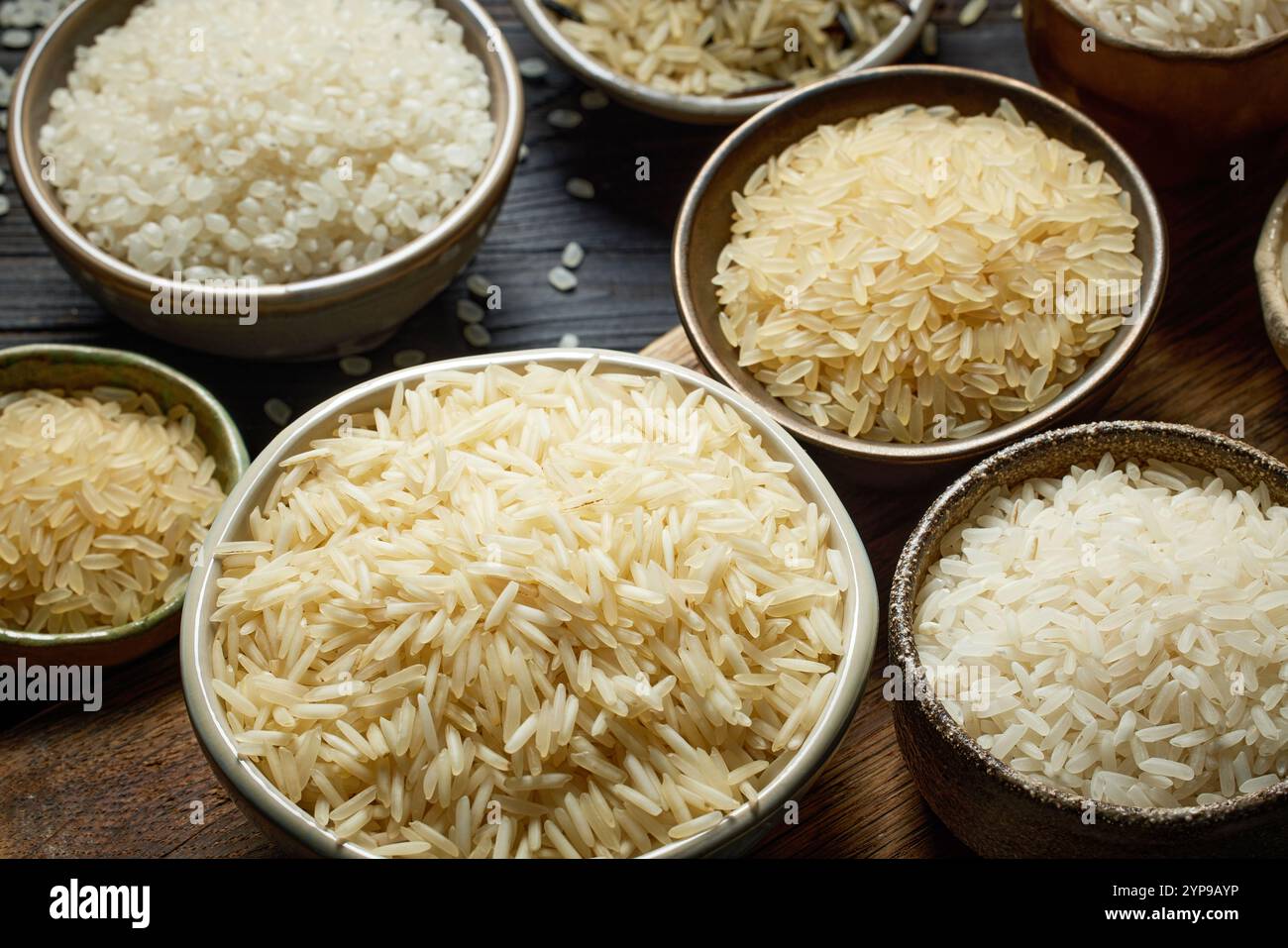 different types of rice on dark wooden table Stock Photo - Alamy