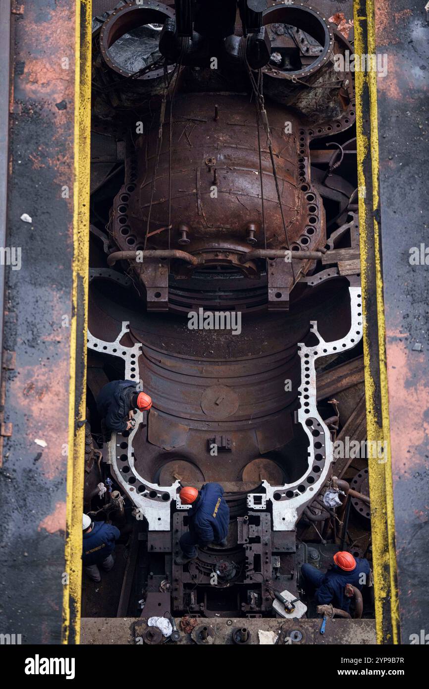 Worker repair equipment at DTEK's power plant after a recent Russian ...