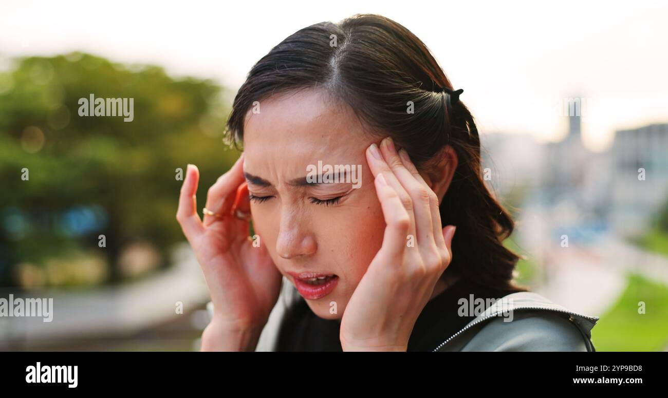 Break, stress and Asian woman with headache in city for workout ...