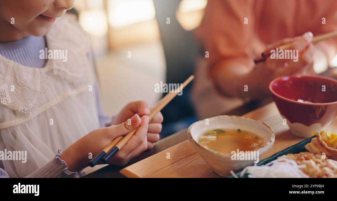 Closeup, child and hands with chopsticks for food, nutrition and ...