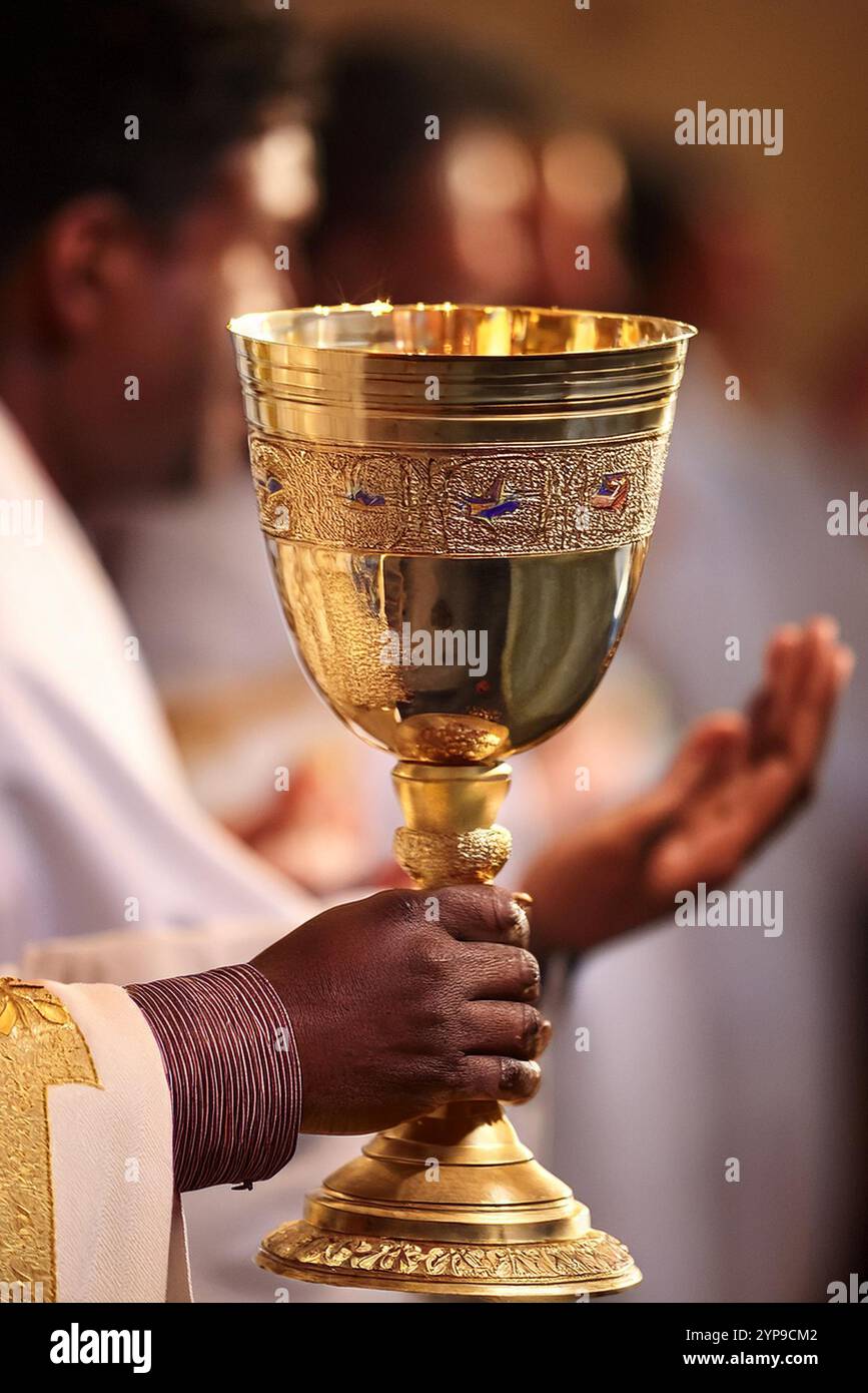Eucharist particles in the hands of the priest in church Stock Photo ...