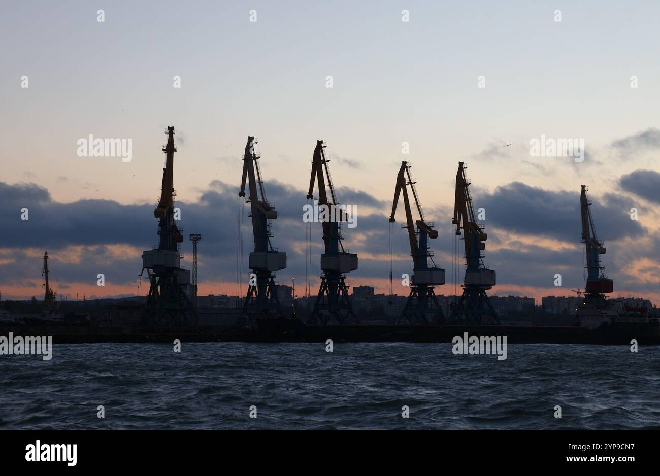 Marine cargo cranes in the seaport in the twilight at dawn Stock Photo ...