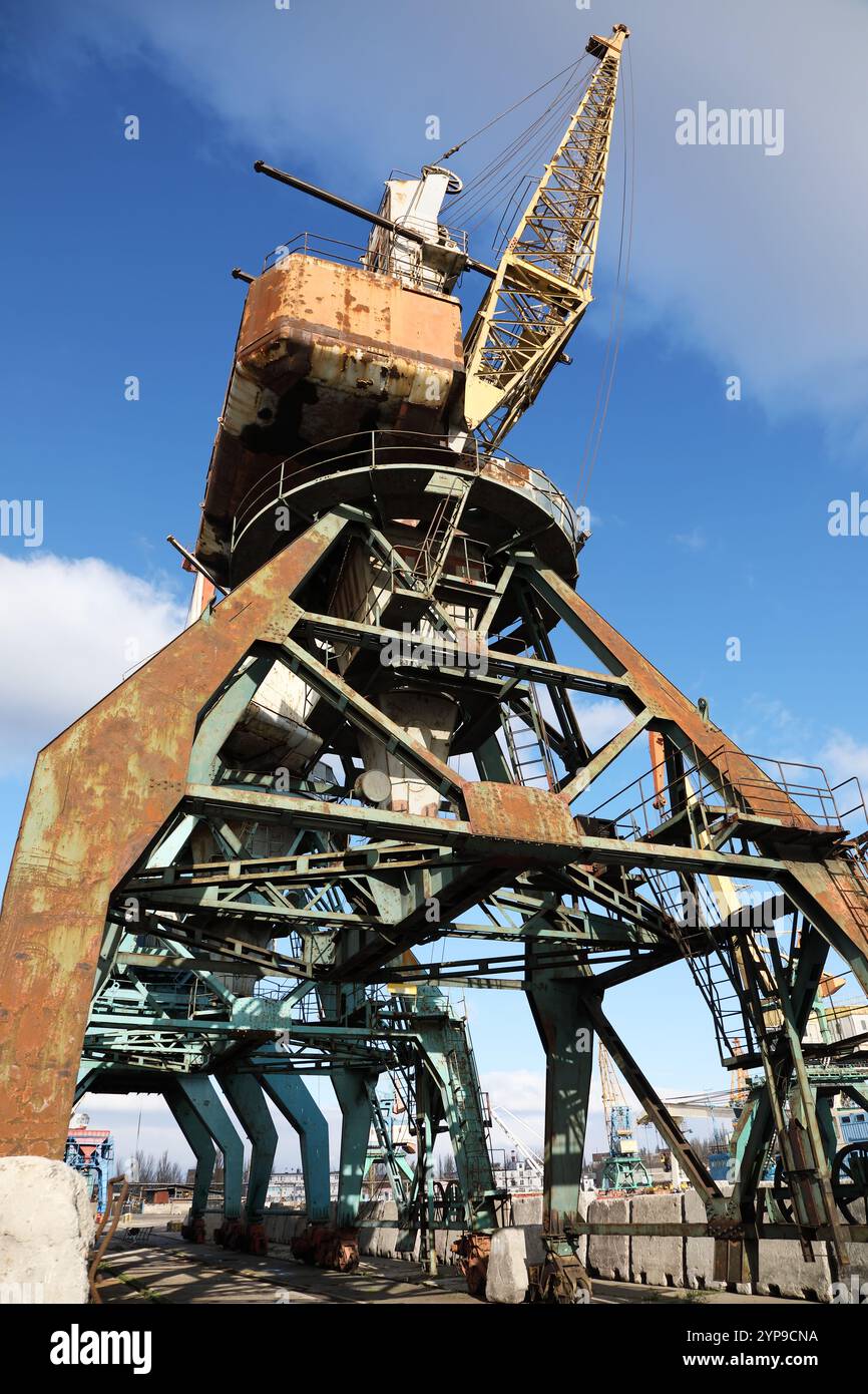 Low angle view of dock crane in the port in front of blue sky with ...