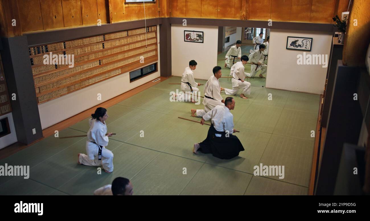 Dojo, class and Aikido exercise group in gym with wood sword Japanese ...