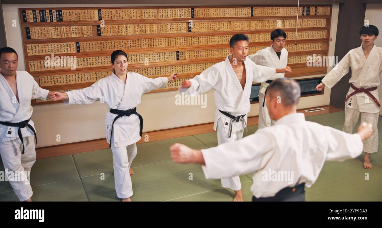 Martial arts, master and Japanese people with learning, exercise and karate etiquette in dojo ...