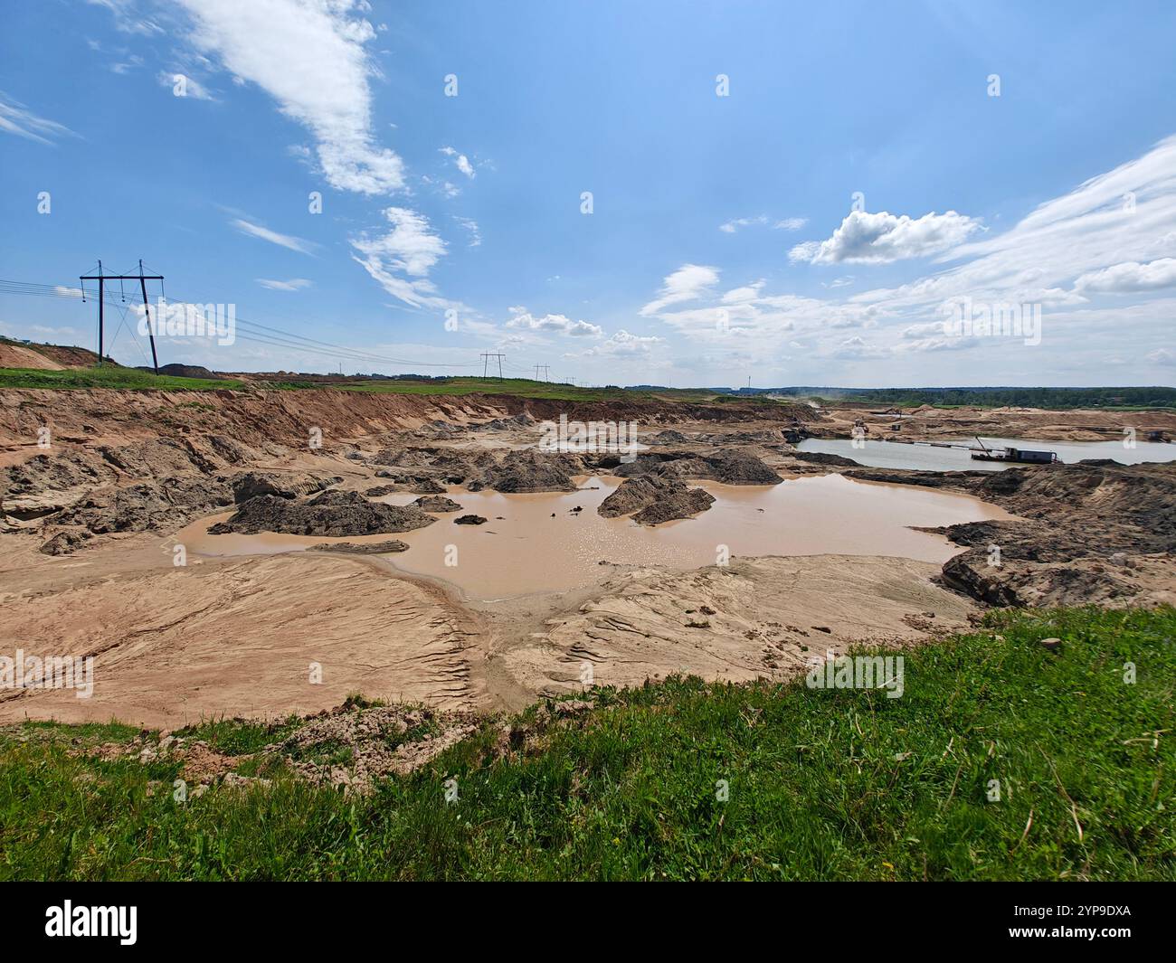 Construction activity is evident at a site with large dirt mounds and a ...