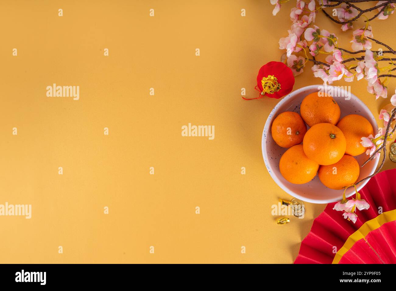 Chinese New Year theme background with copy space. Red fans, gold coins ...