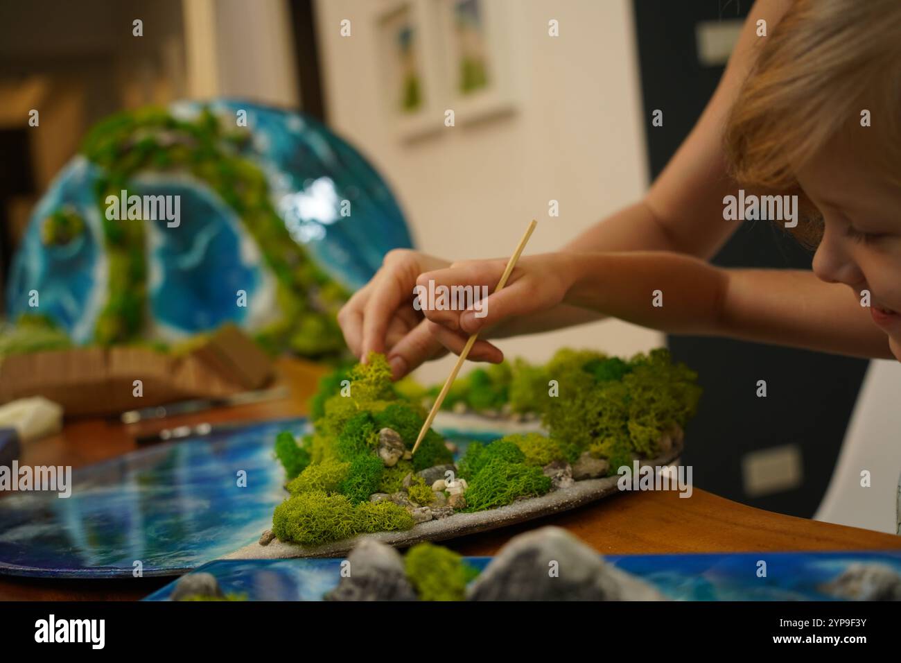 A mother and her daughter craft vibrant natural landscapes Stock Photo ...