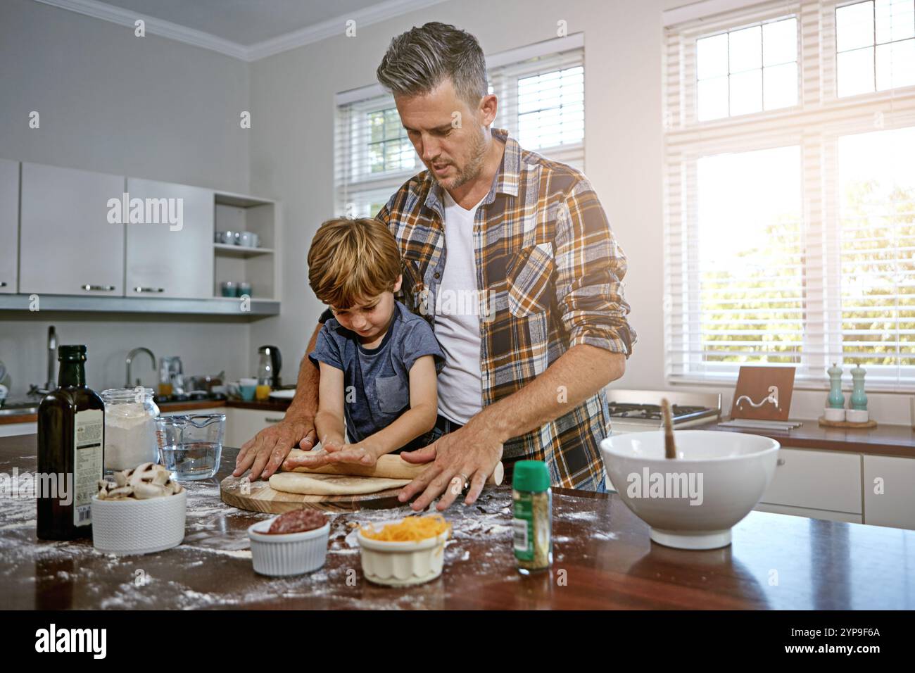 Father, son and cooking help in kitchen for teaching with pizza ...
