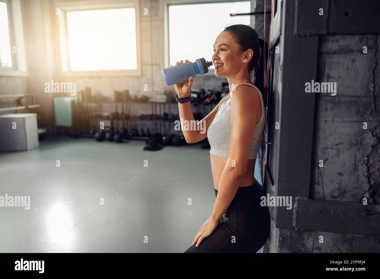 An Active Woman Hydrating After Completing Her Workout at a Modern Fitness Gym Today Stock Photo ...