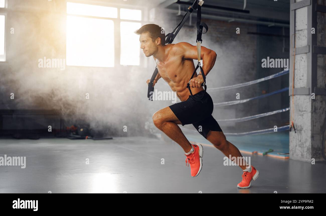 Engaging in Dynamic Fit Male Training that utilizes a Suspension System ...