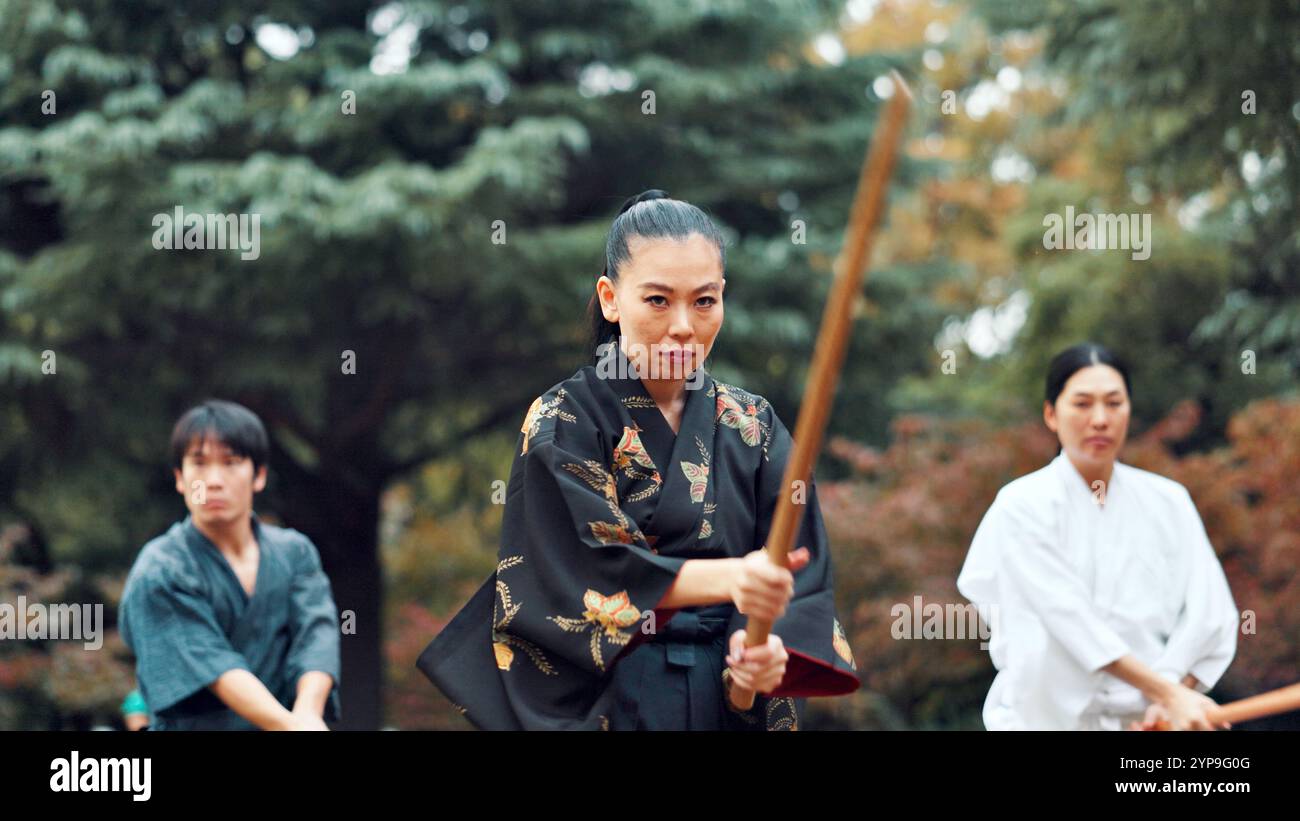 Martial arts, park and instructor with wood sword for fight, battle and samurai training class ...