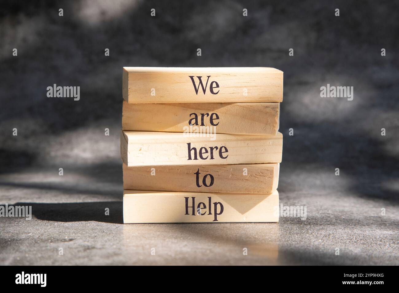 We are here to help symbol. Concept words we are here to help on wooden ...