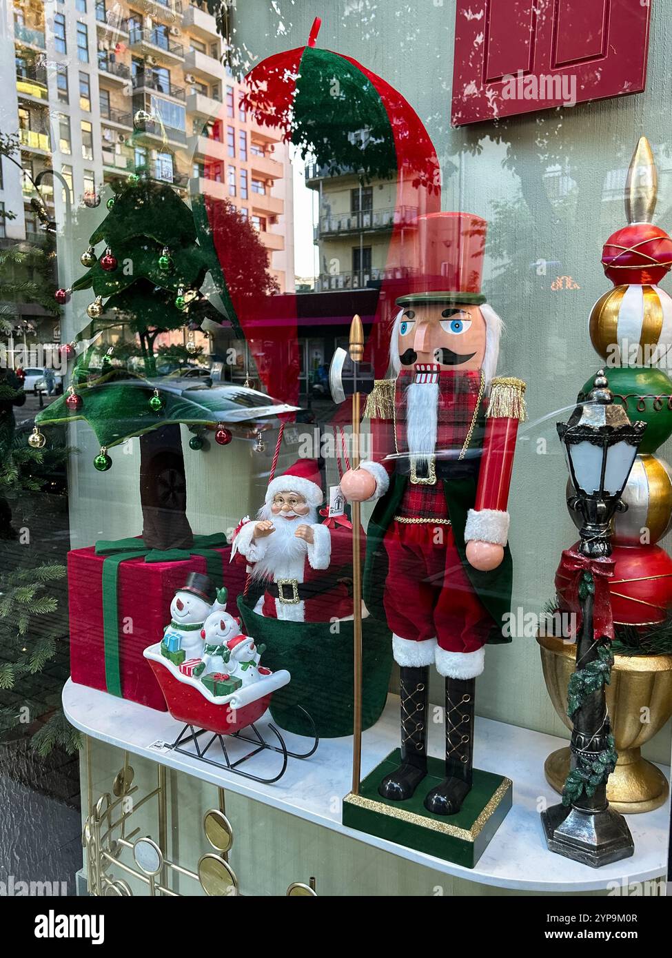 This vertical photo captures a festive winter shop window display that ...