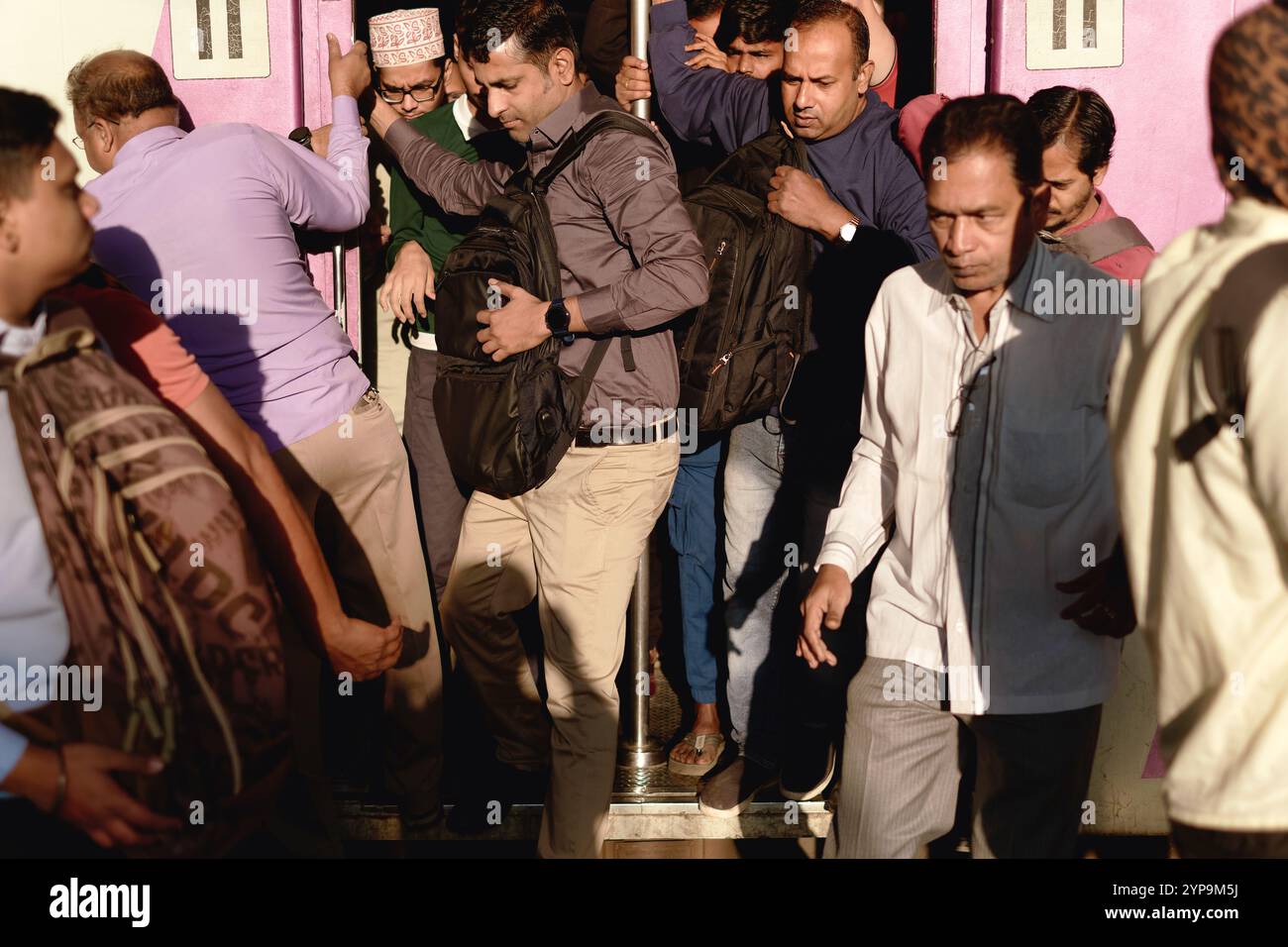 Passengers are pushing their way out of a suburban train at Dadar ...