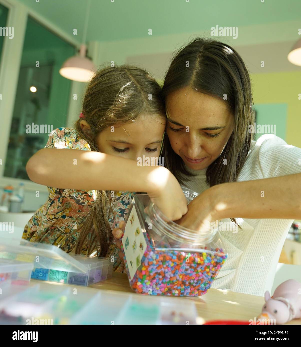 Teacher in workshop teched two girls how to assemble a thermo mosaic ...