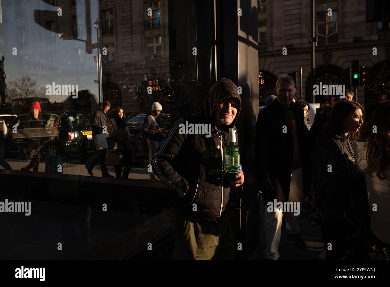 Homeless man holding a bottle of Stella Artois along Piccadilly, London ...