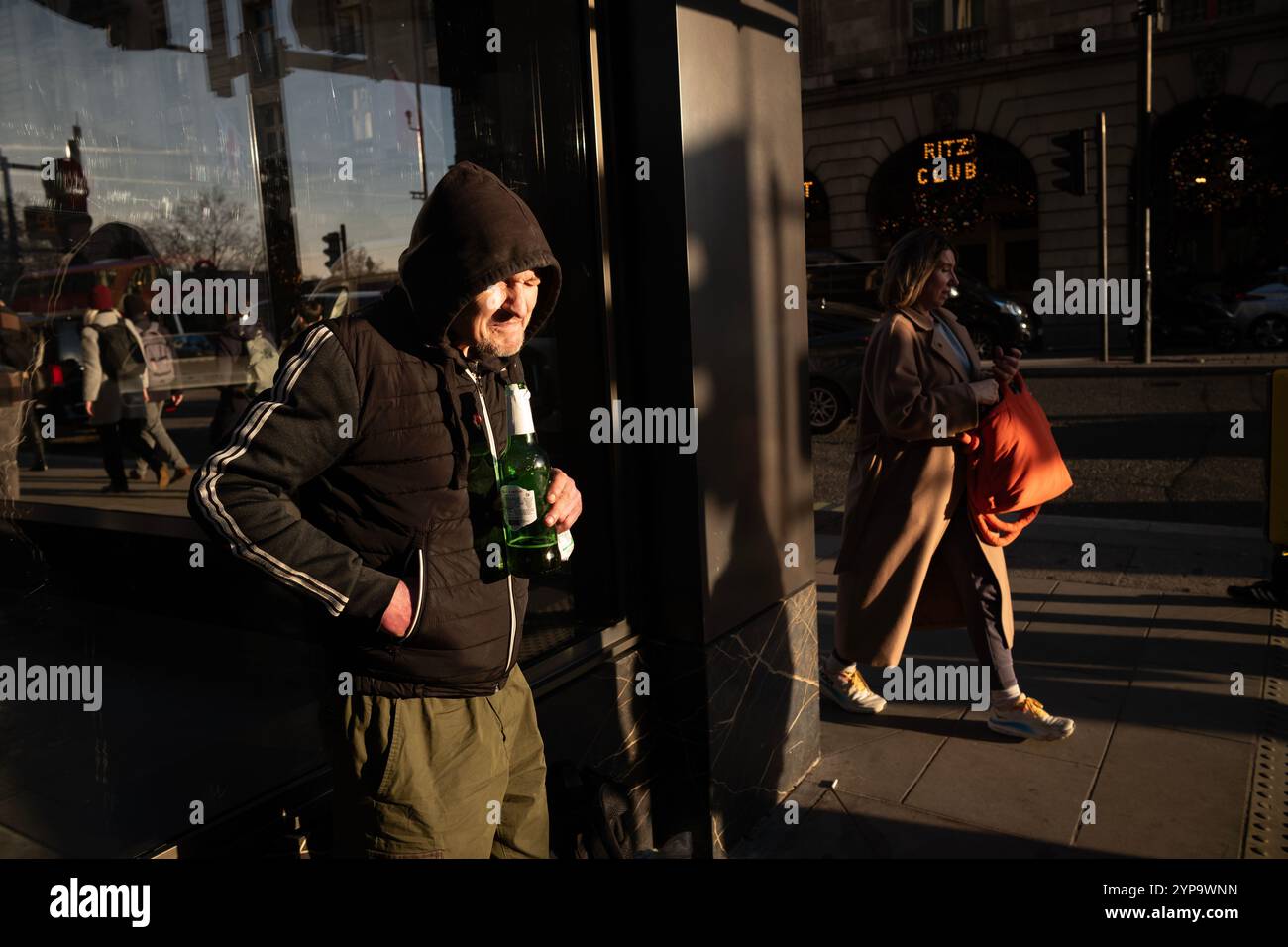 Homeless man holding a bottle of Stella Artois along Piccadilly, London ...