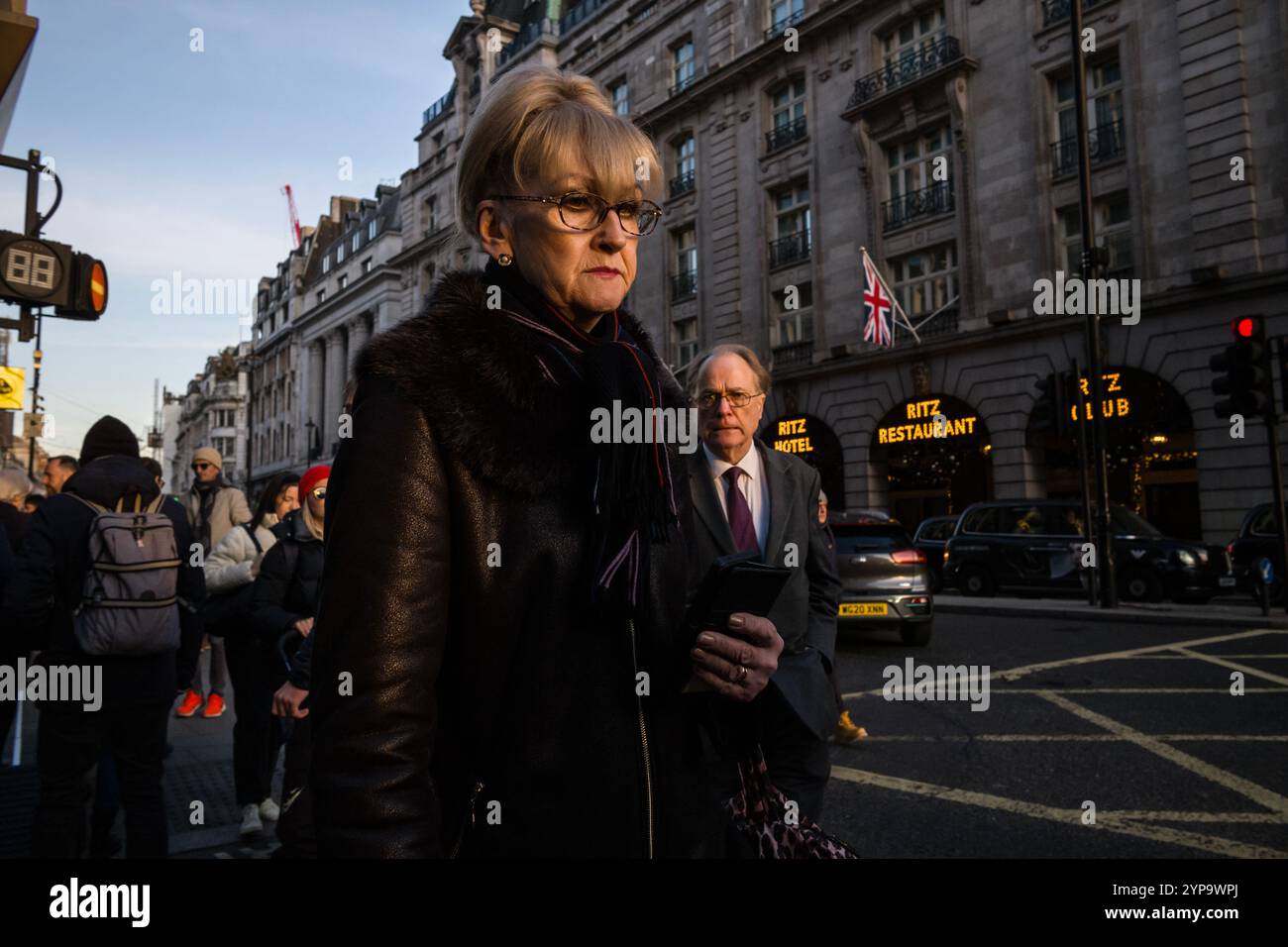 A lady walks down Piccadilly on the opposite side of the RITZ hotel and ...