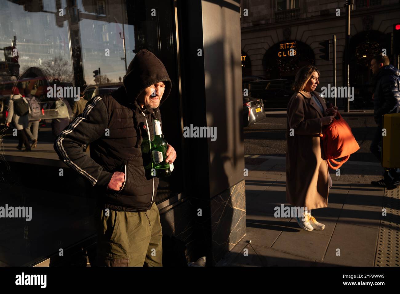 Homeless man holding a bottle of Stella Artois along Piccadilly, London ...