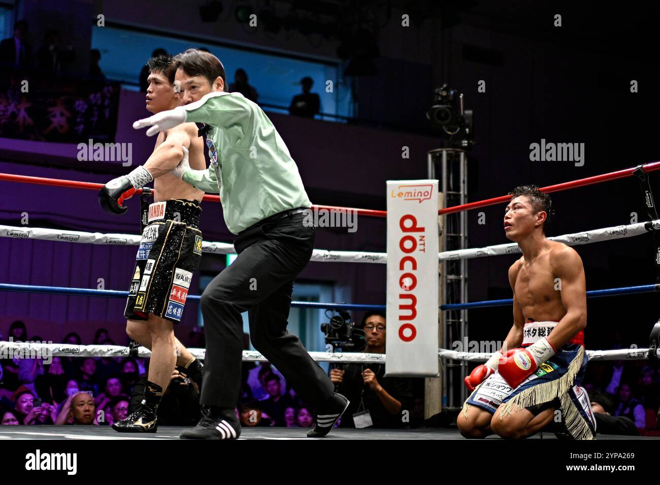 Tokyo, Japan. 21st Nov, 2024. Shu Utsuki (black gloves) is led to a neutral corner by referee ...