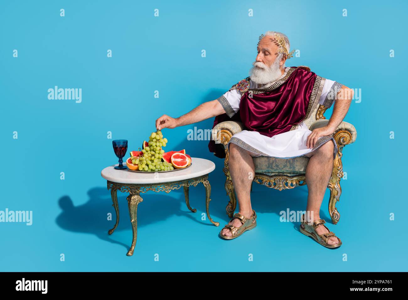Full size photo of ancient leader prophet sit throne eat fresh grapes ...