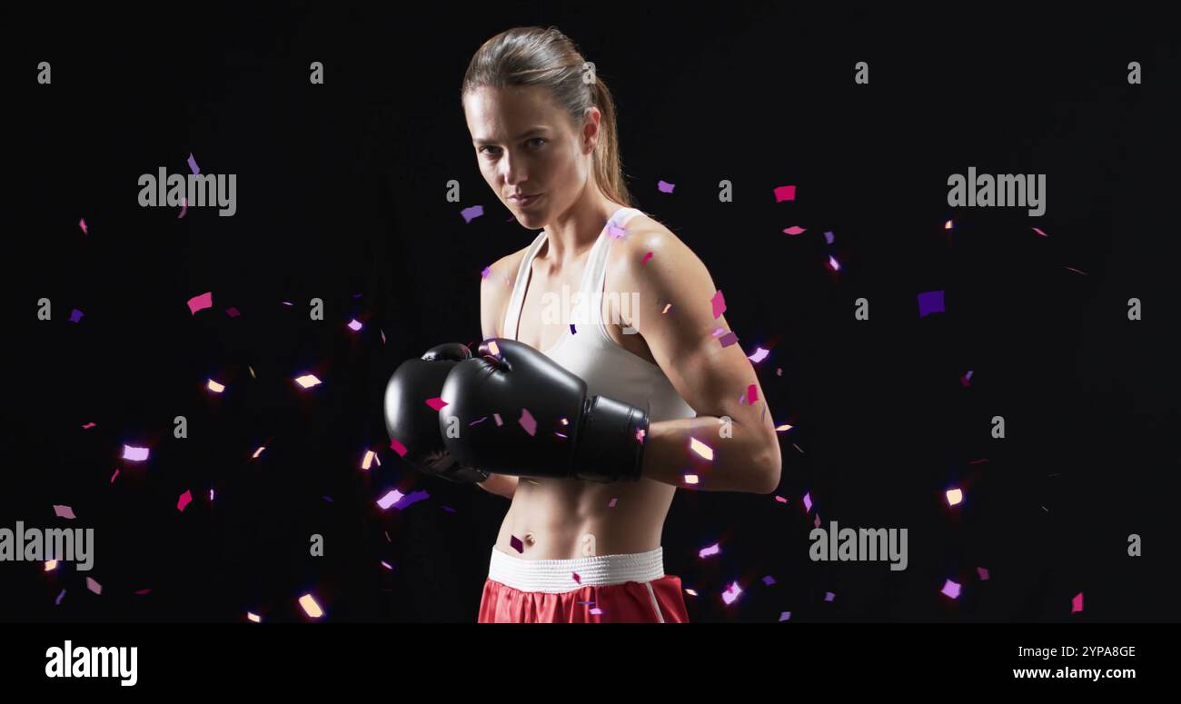Image of confetti falling over caucasian female boxer on black ...