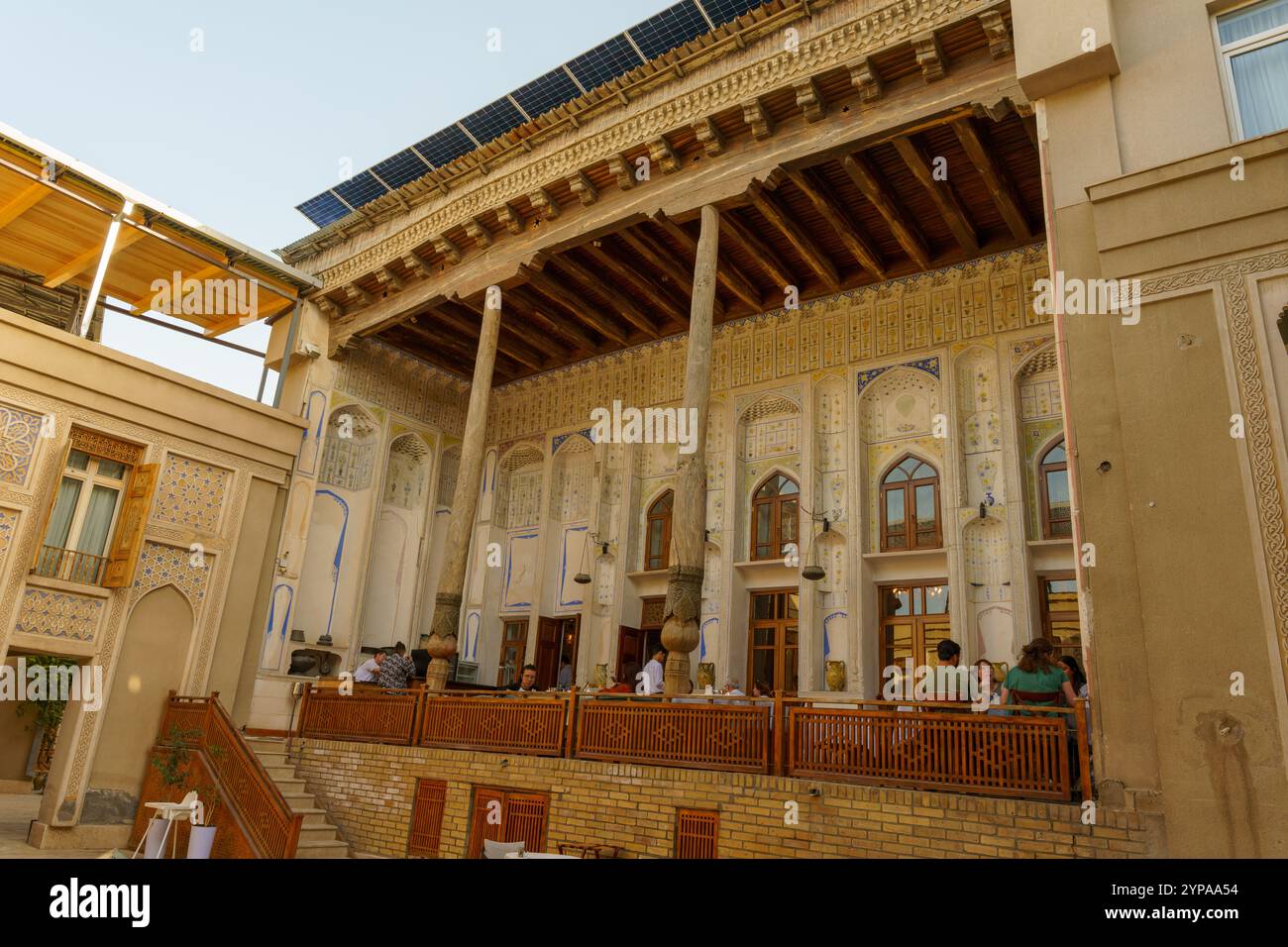 A building with a balcony and a large archway Stock Photo - Alamy