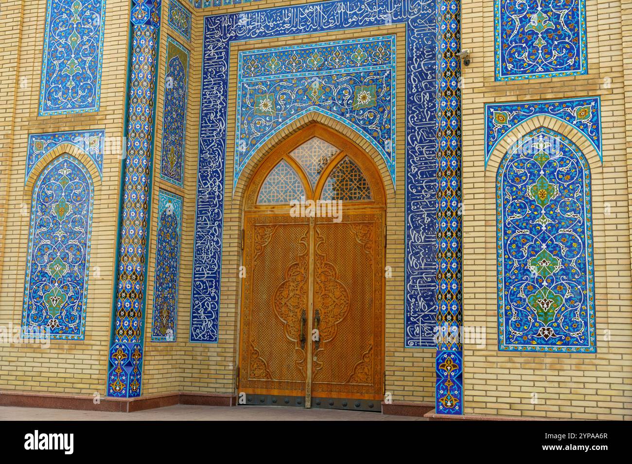 The blue and white building has a beautiful arched doorway Stock Photo ...