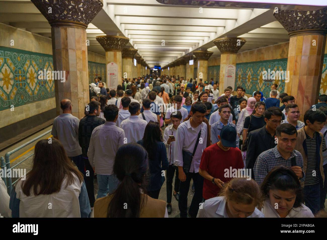 A crowded subway station with people walking and talking Stock Photo - Alamy