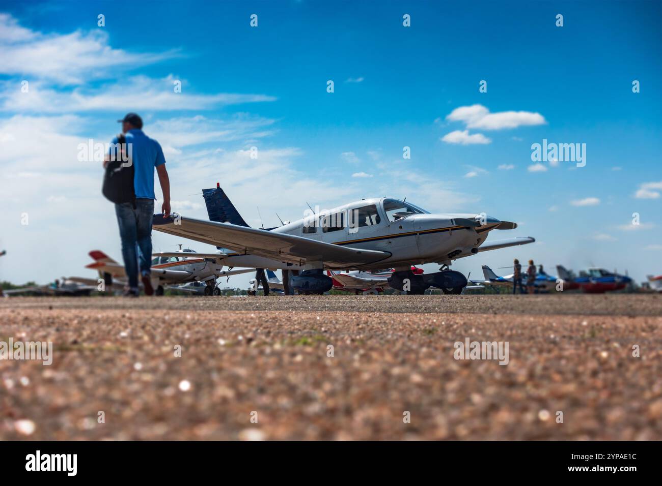 A man walks near a single-engine plane Stock Photo - Alamy