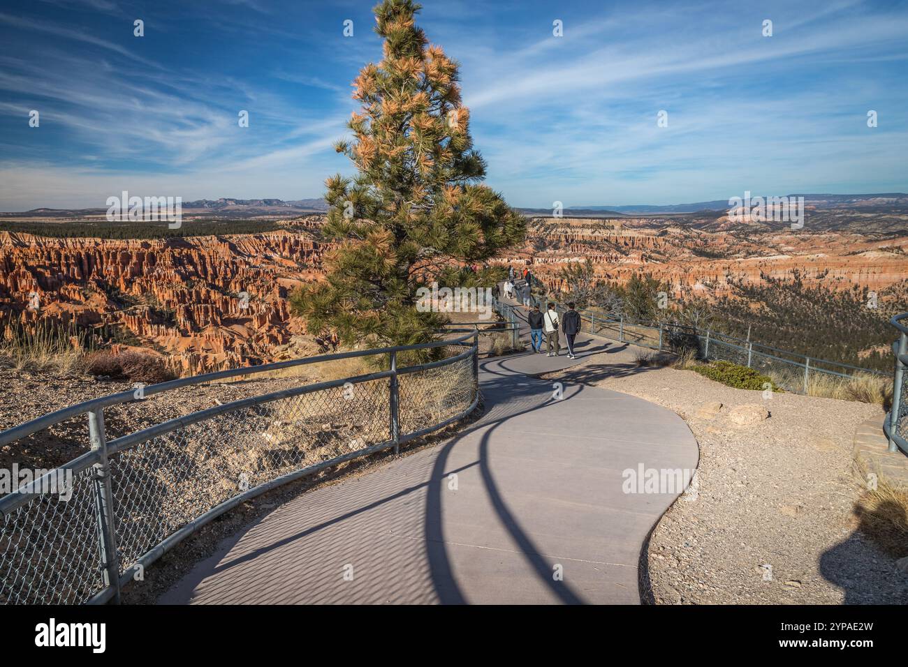 Visitors stroll along the Rim Trail at Bryce Point in Bryce Canyon ...