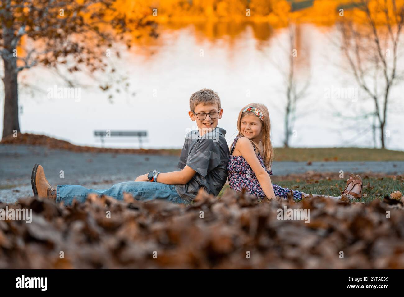 Brother and Sister back to back looking at each other Stock Photo - Alamy