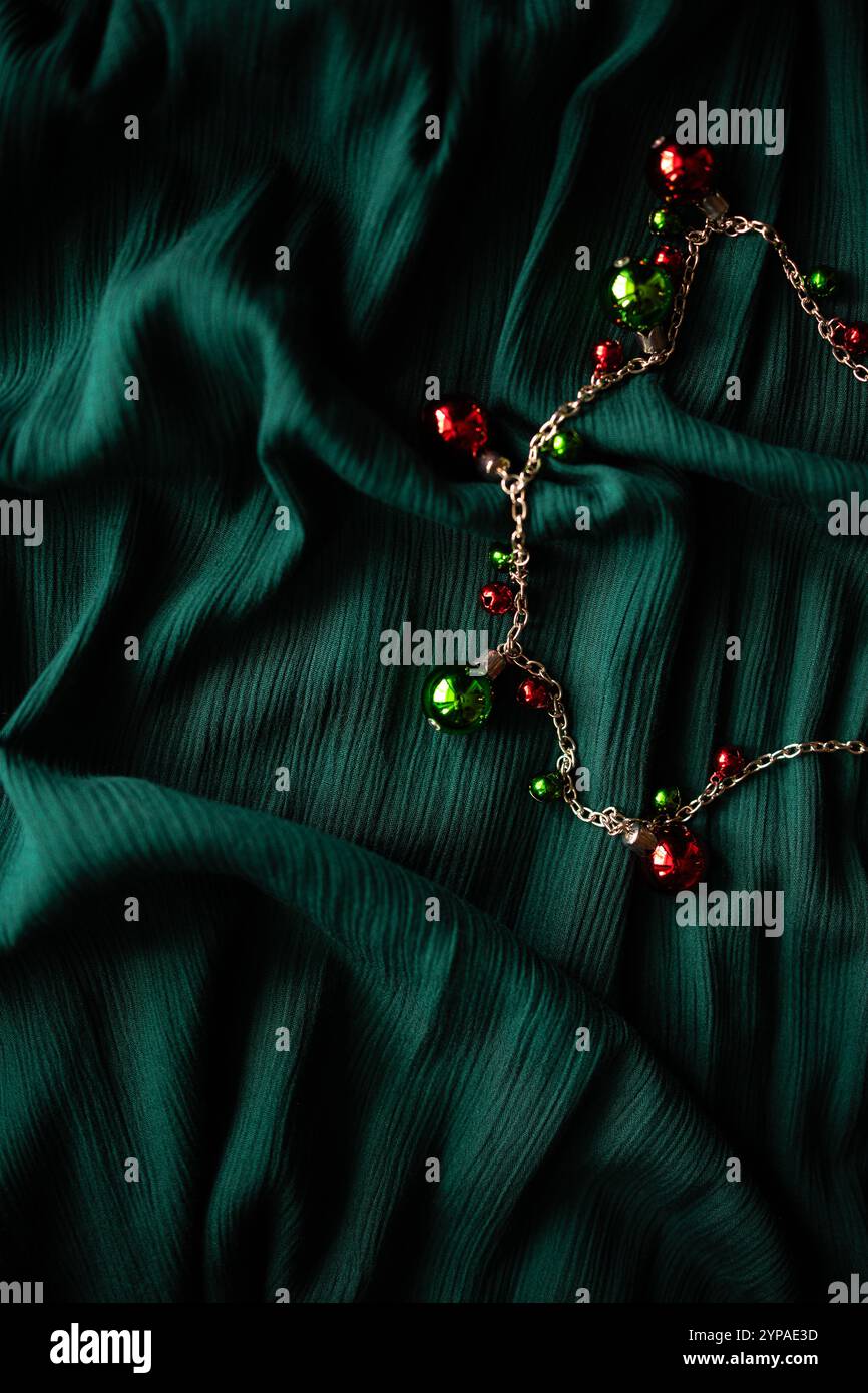 red and green Christmas bells on dark green fabric with copy space ...