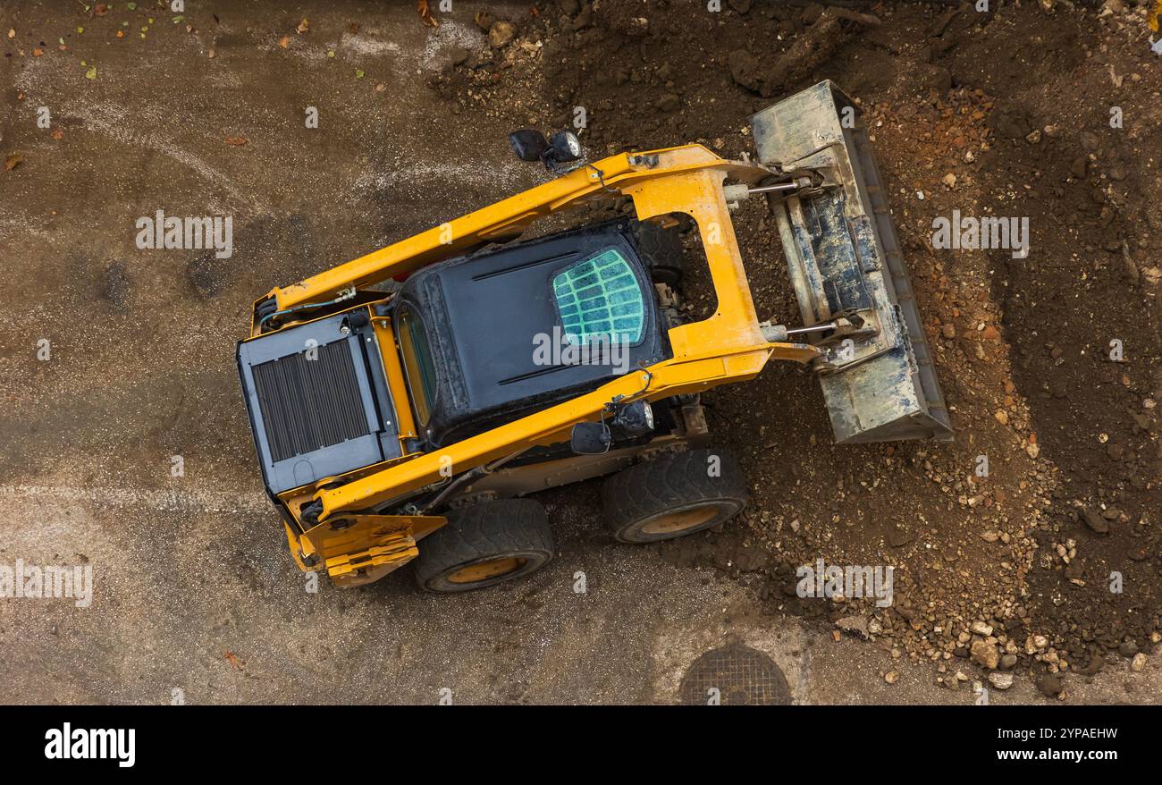 Powerful bulldozer or loader moves the earth at the construction site ...