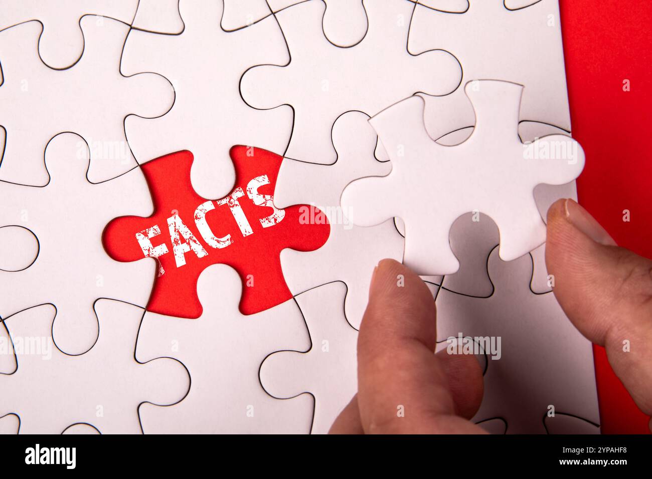 FACTS. White puzzle pieces on an red background Stock Photo - Alamy