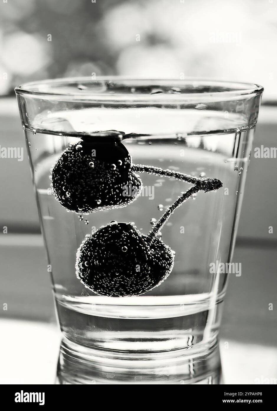 Double Cherry in a glass side view Stock Photo - Alamy