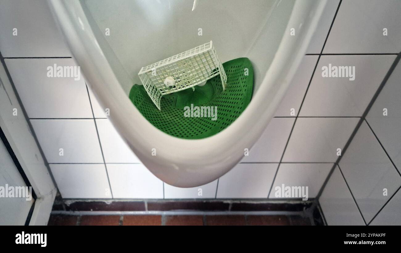 football goal with ball in a urinal Stock Photo - Alamy