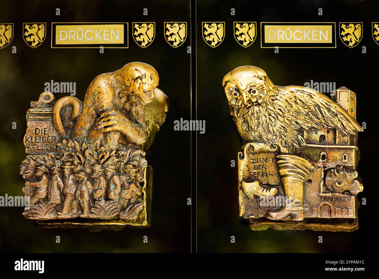 Door handles on the glass door of the town hall with motifs from the ...