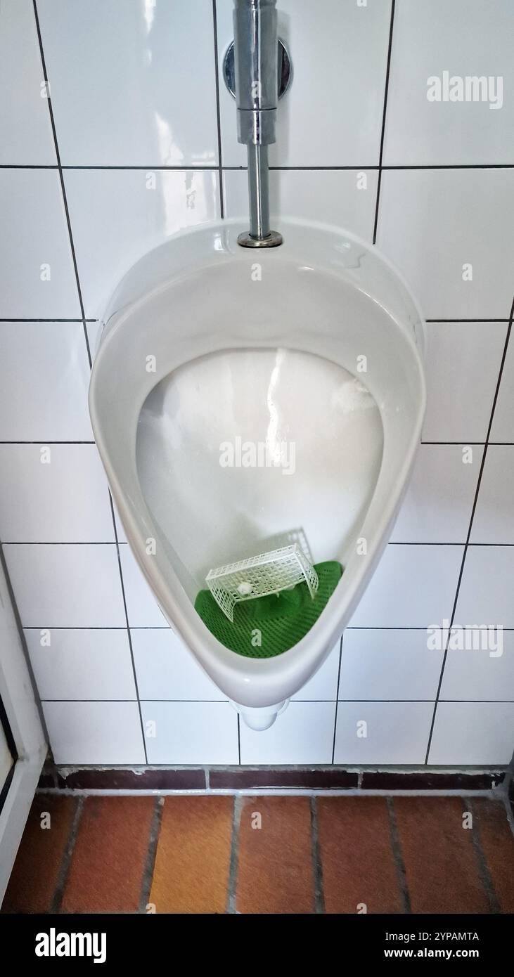 football goal with ball in a urinal Stock Photo - Alamy