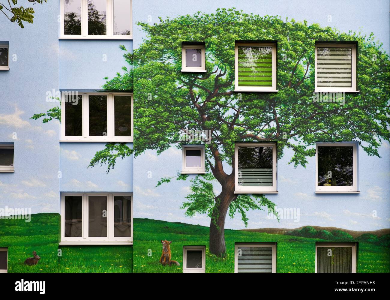Residential building with painted tree on the façade after energy ...