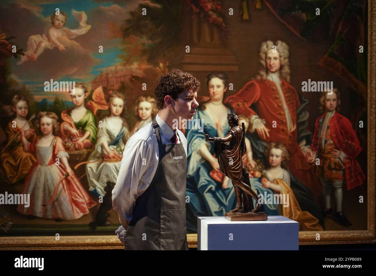 A member of staff poses next to the Apollo Belvedere bronze sculpture ...