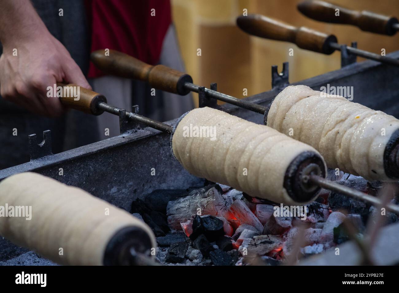 Cooking sweet buns on a spit Stock Photo - Alamy