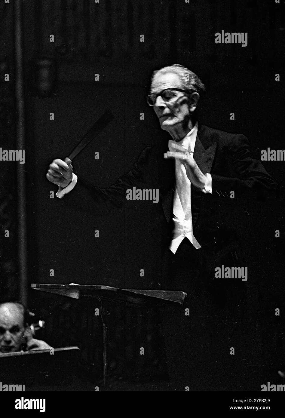 Swiss composer Frank Martin conducting an orchestra at the Teatro Odeón ...