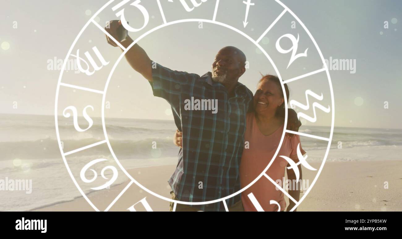Image of horoscope over happy senior biracial couple walking at beach ...