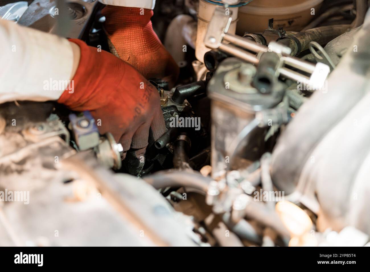 Automotive Mechanic Repairing Engine Components with Gloved Hands Stock ...