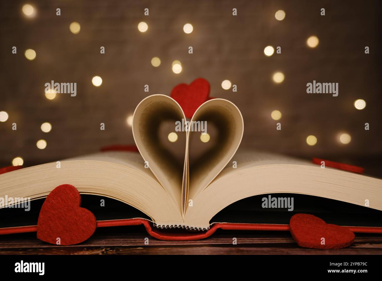 Open book with pages forming a heart shape, decorated with red felt ...