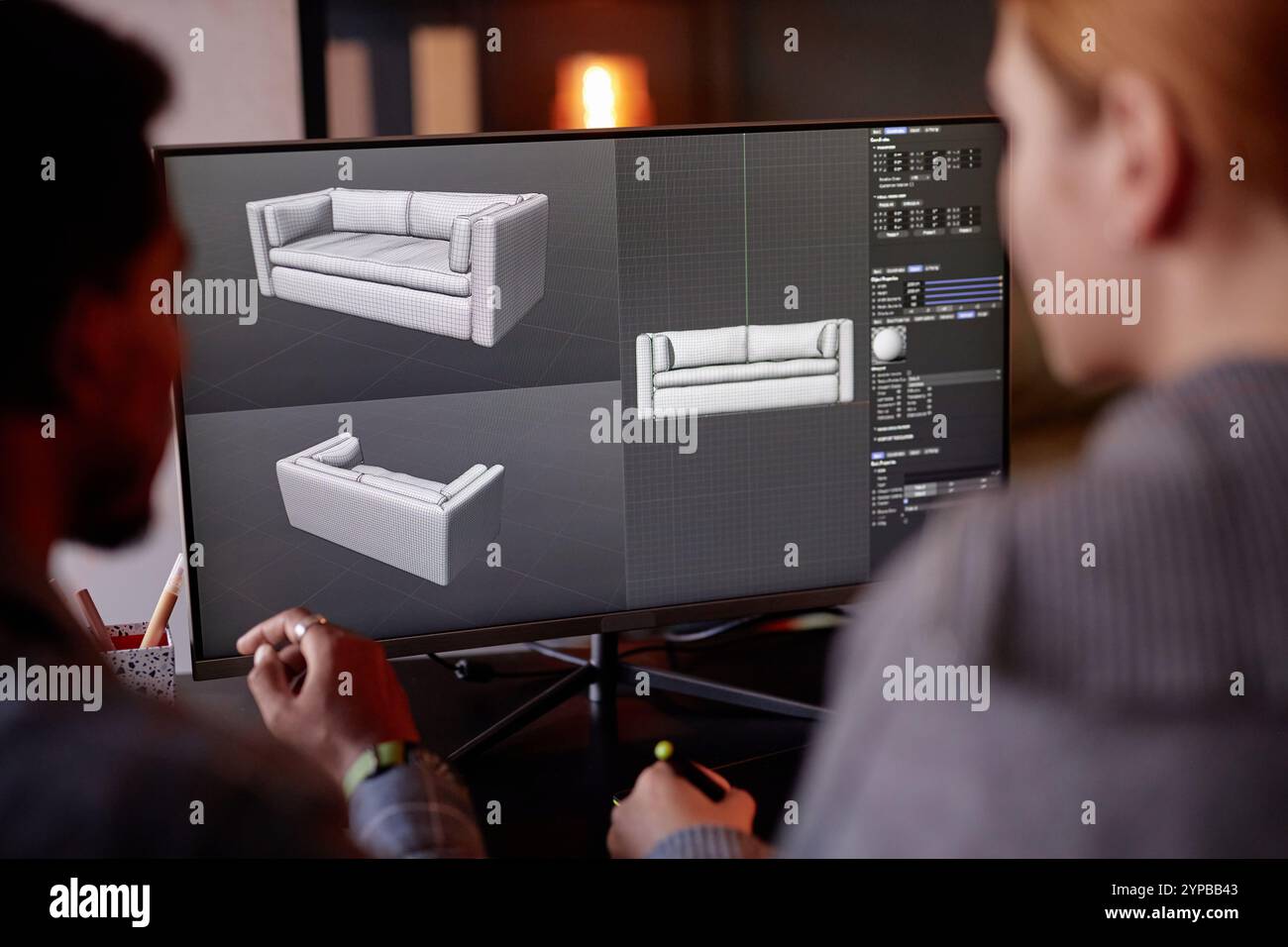 Two designers working on creating 3D models of furniture using ...