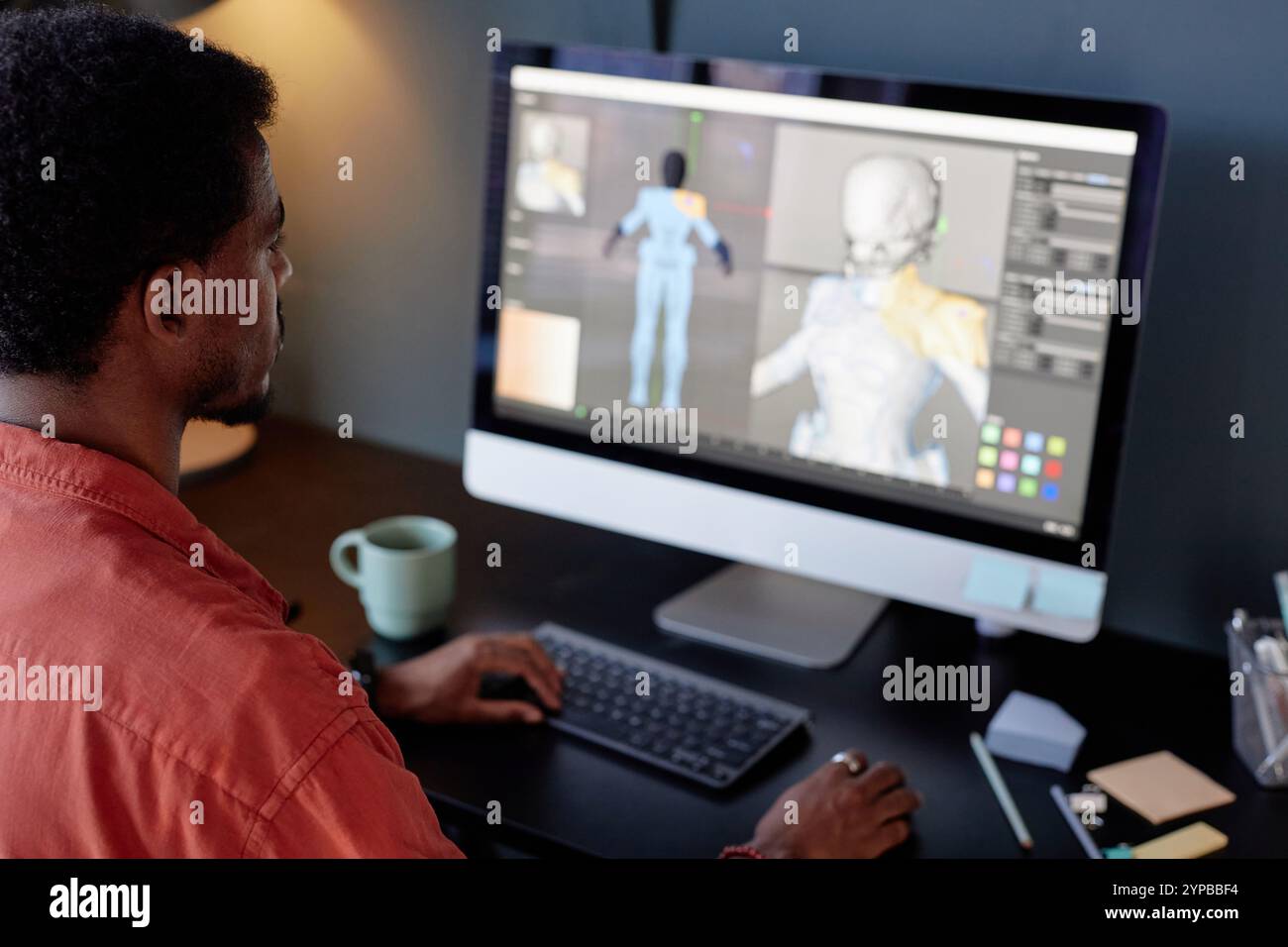 Individual sitting at desk while handling a 3D modeling project on ...